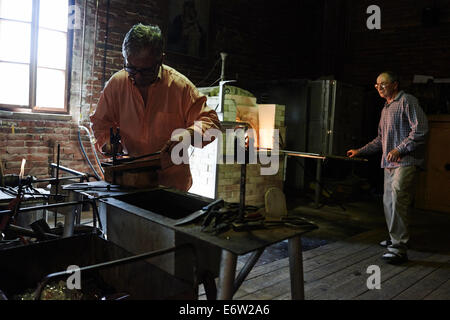 Glassmakers, Glassblowers forming molten glass, glass factory, Ajeto ...
