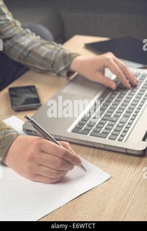 Side view of young female programmer in vr headset using laptop to ...