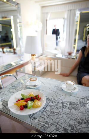 Two women with cups of coffee on bright background Stock Photo - Alamy