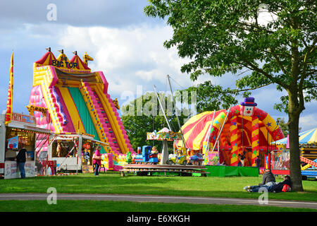 Rides and inflatables at touring funfair in Gadebridge Park, Hemel ...