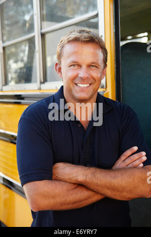 Smiling driver driving the school bus Stock Photo - Alamy