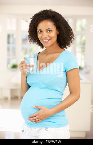 Woman drinking water while standing on road against sea Stock Photo - Alamy