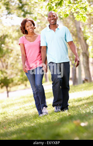 Happy young couple walking outdoors Stock Photo - Alamy