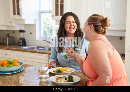Two Overweight Women On Diet Eating Healthy Meal In Kitchen Stock Photo ...