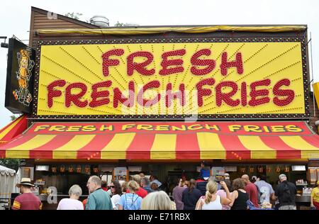 A crowd of people at a french fries stand at the Minnesota State Fair ...
