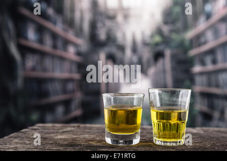 glass shots with yellow liqour resembling whiskey, rum, tequila, spirit ...