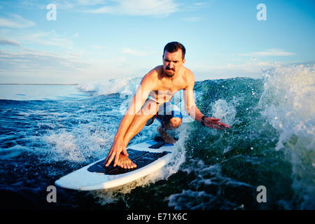 Male surfboarder practicing surfboarding Stock Photo - Alamy