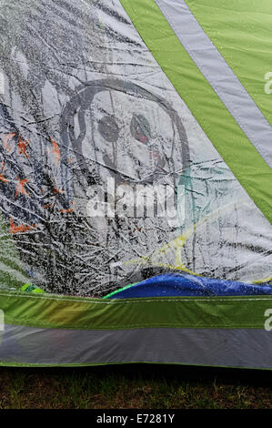 hand drawn smiley face drawn into condensation on a tent while camping ...