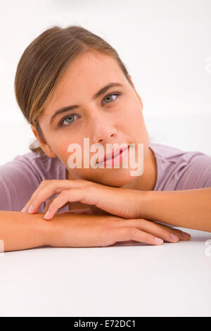 Young woman leaning forward desk looking cellphone Stock Photo - Alamy