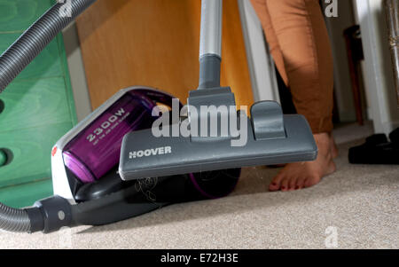 Powerful pull along Hoover vacuum cleaner being used on domestic carpet ...