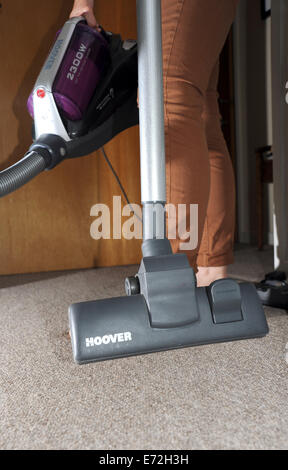 Powerful pull along Hoover vacuum cleaner being used on domestic carpet ...