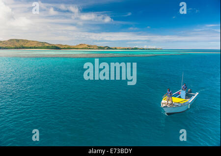 Little boat in the blue lagoon, Yasawa, Fiji, South Pacific Stock Photo ...
