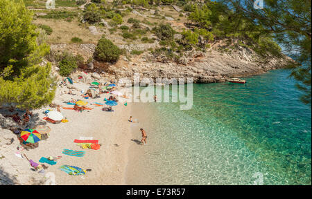 Tourists on Lucisca beach near Sveta Nedilja village, Hvar island ...