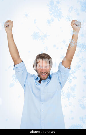 Happy young man celebrating success, studio shot on gray background ...