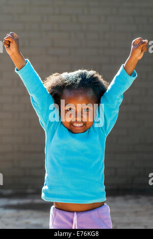 Happy small kid raising his arms isolated on a white background Stock ...