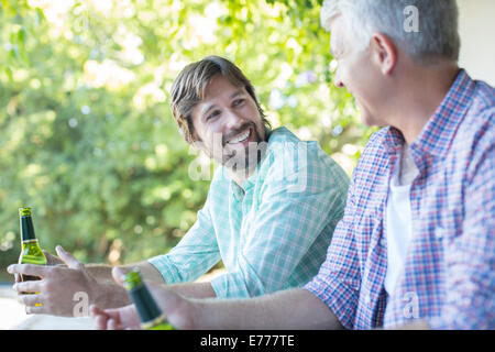 Father and adult son drinking beer Stock Photo - Alamy