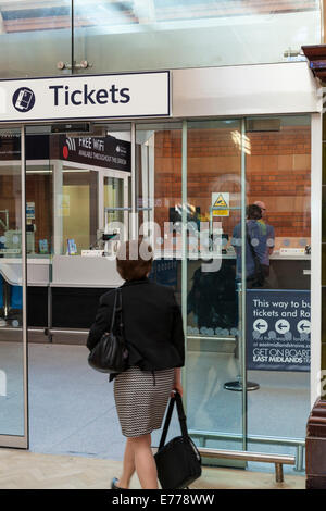 Person entering a train station Stock Photo - Alamy