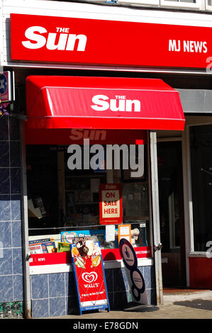 News agent shop with Sun newspaper logo Stock Photo - Alamy