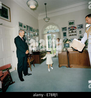 John F. Kennedy, Jr., plays with his dog, Shannon, at Brambletyde house ...