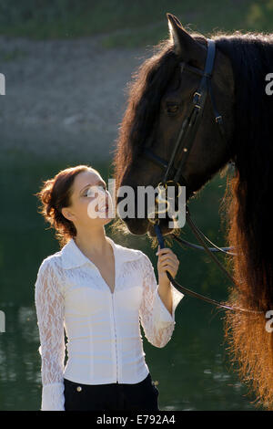 woman with Friesian Horse Stock Photo - Alamy