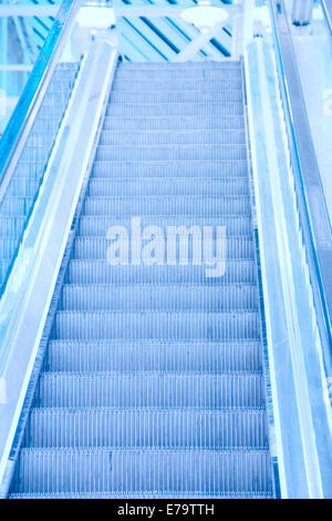 Perspective of escalator toned in blue color Stock Photo - Alamy