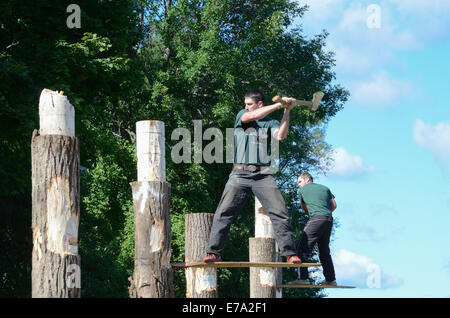Lumberjack and lumberjill compete in a tree climbing competition at the ...