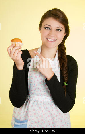 Beautiful young brunette pastry chef woman cooking pastries at the ...