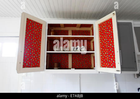 vintage kitchen cupboard with red fablon inside Stock Photo - Alamy