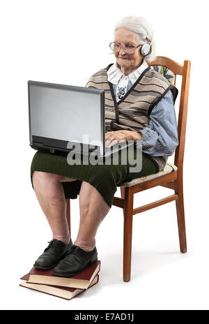 Grandmother looking at laptop using one hand typing searching internet ...
