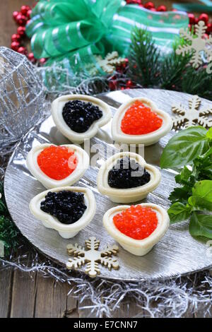 Festive Christmas appetizer tartlets stuffed with red caviar and a ...