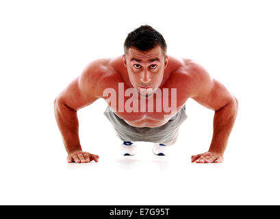 Muscle man making push ups in studio, isolated over a white background ...
