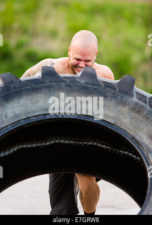 Determined Athlete Flipping Tractor Tire Stock Photo - Alamy