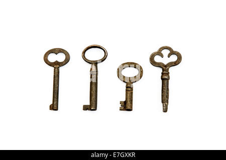 Closeup of four decorative antique keys. Hanging from brown rope. On a ...