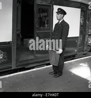 1950s historical picture, railway guard coupling or shunting ...