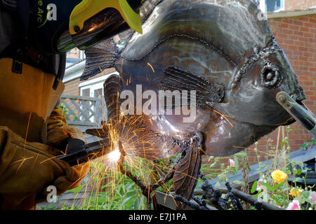 Sculptor stick welding a metal fish Stock Photo - Alamy
