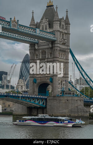 Tourist boat underneath Tower bridge in London Stock Photo - Alamy