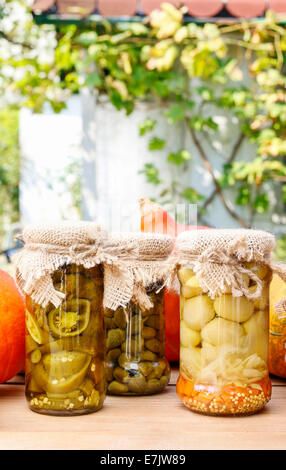 Pickled vegetables in a jar on a wooden table Stock Photo - Alamy