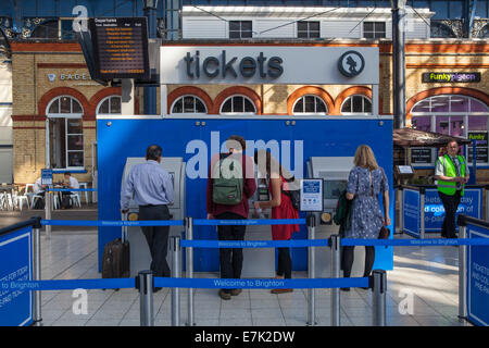 Rail passengers use self-service ticket machines at London Bridge train ...