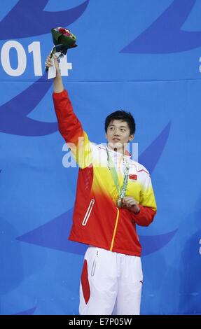 Shun Wang of China, poses with his bronze medal for the men's 200-meter ...