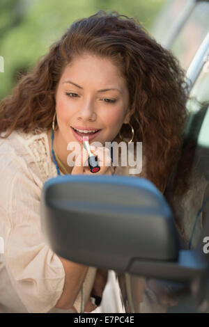 Hispanic woman with curly hair standing over isolated background ...