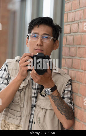 Black mid man looking at camera while posing with arms crossed isolated ...