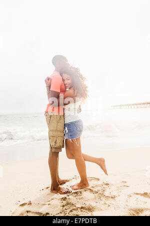 Young hispanic couple standing over yellow background covering eyes ...