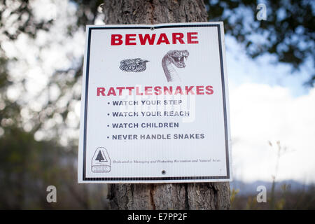 Sign with a danger warning beware of rattlesnakes for hikers Stock ...