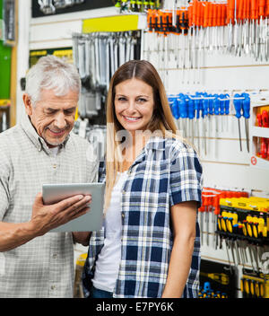 Woman and man discussing shopping list in building store Stock Photo ...