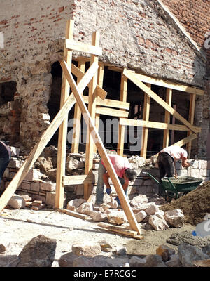 Workers build structure with wooden frames beams bracing in ...