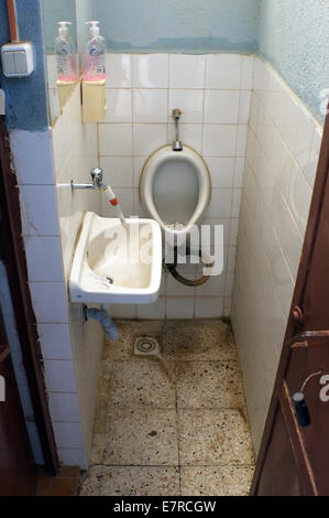 Narrow bathroom with, toilet, small washbasin, decorated with gray ...