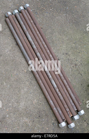 Rusty steel threaded rods bars with yellow protection caps. Covers ...