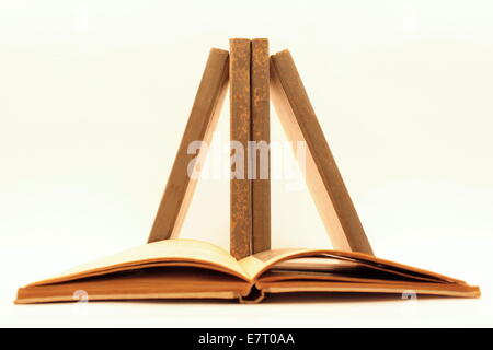 Open book and four vertically above white background Stock Photo - Alamy