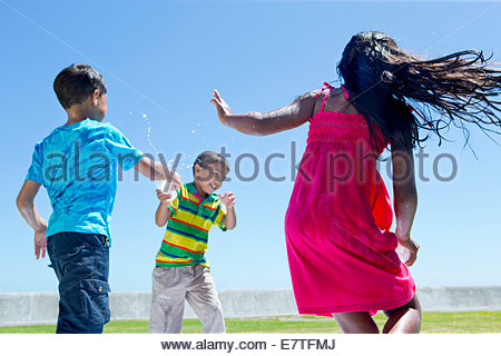 Girls having water fight with water pistols Stock Photo: 52216858 - Alamy