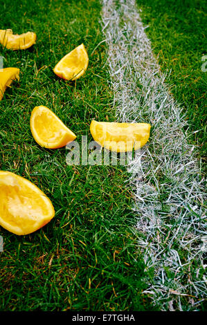 Eaten Half Time Orange Quarters On A Sports Pitch Stock Photo - Alamy